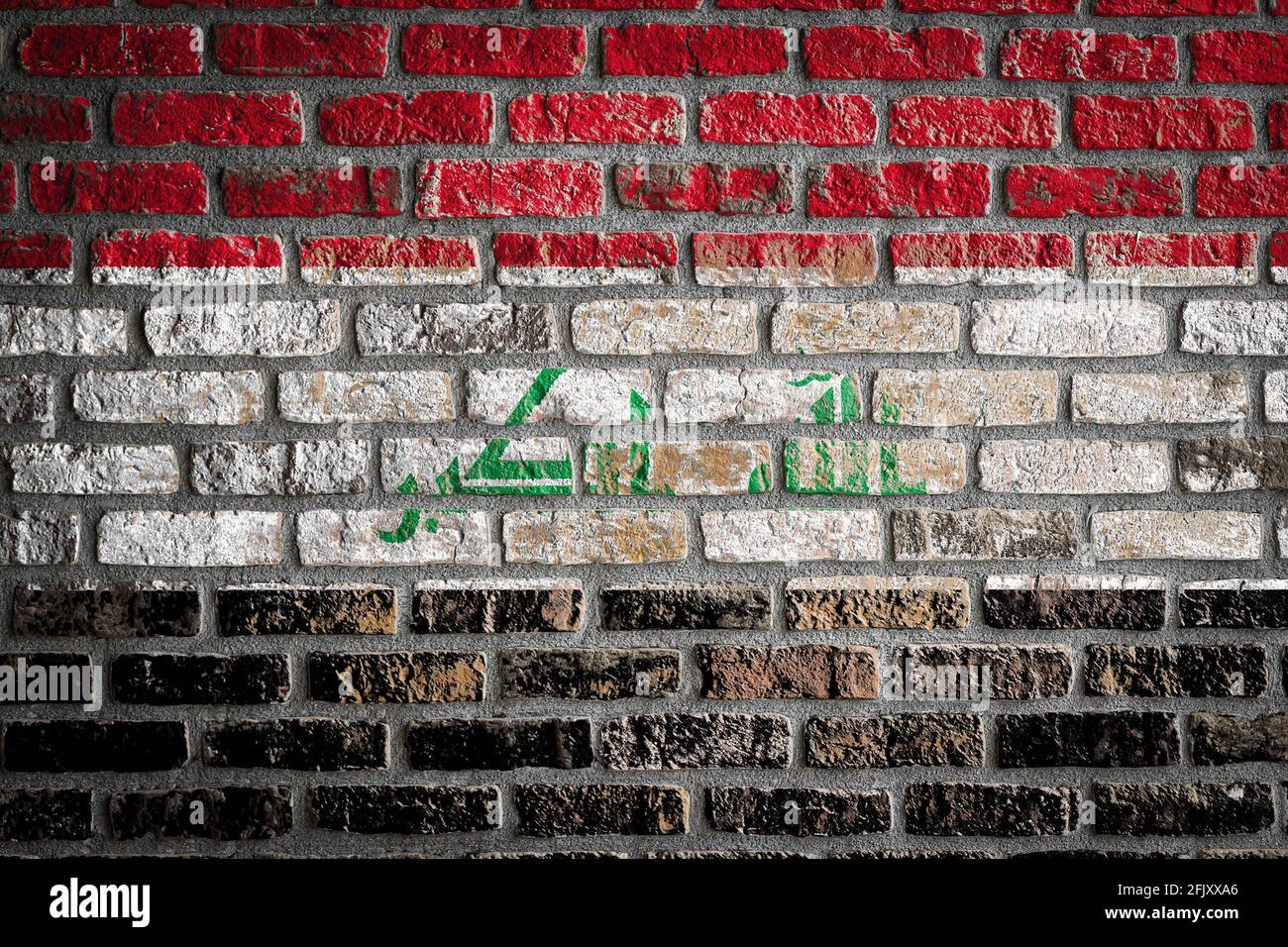 National flag of Irak depicting in paint colors on an old brick wall ...