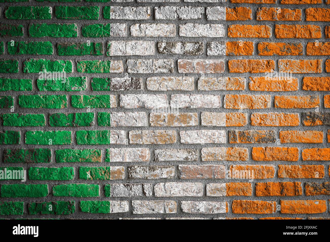 National flag of Ireland depicting in paint colors on an old brick wall ...