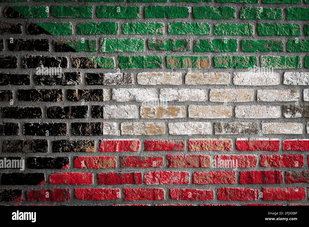 National flag of Kuwait depicting in paint colors on an old brick wall ...