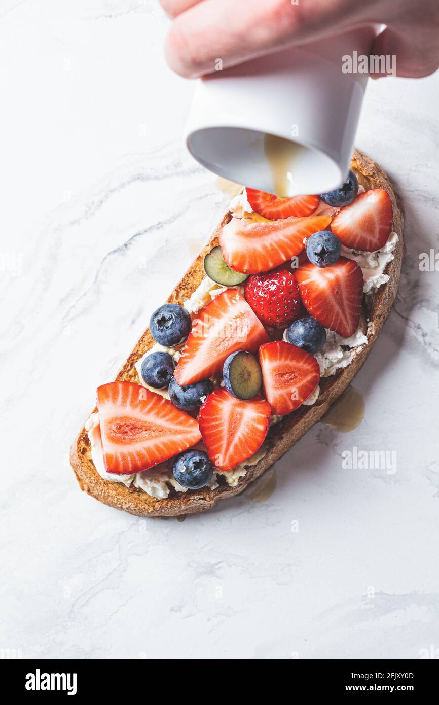 Toast with cream cheese, strawberries, blueberries and maple syrup ...