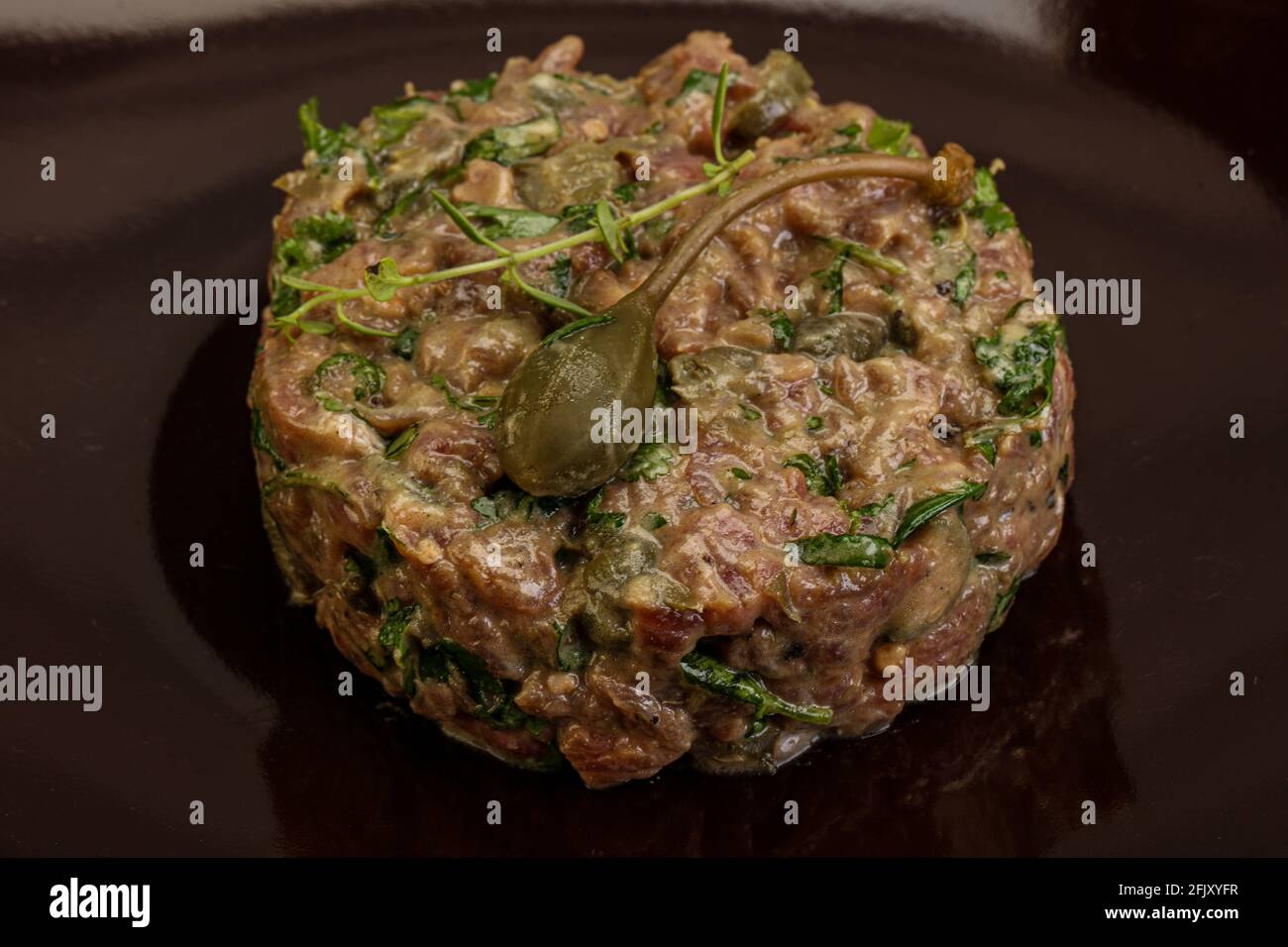 Raw beef tartar snack with capers Stock Photo - Alamy
