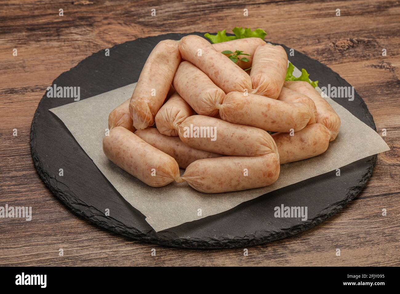 Raw natural chicken baby sausages for roast Stock Photo - Alamy