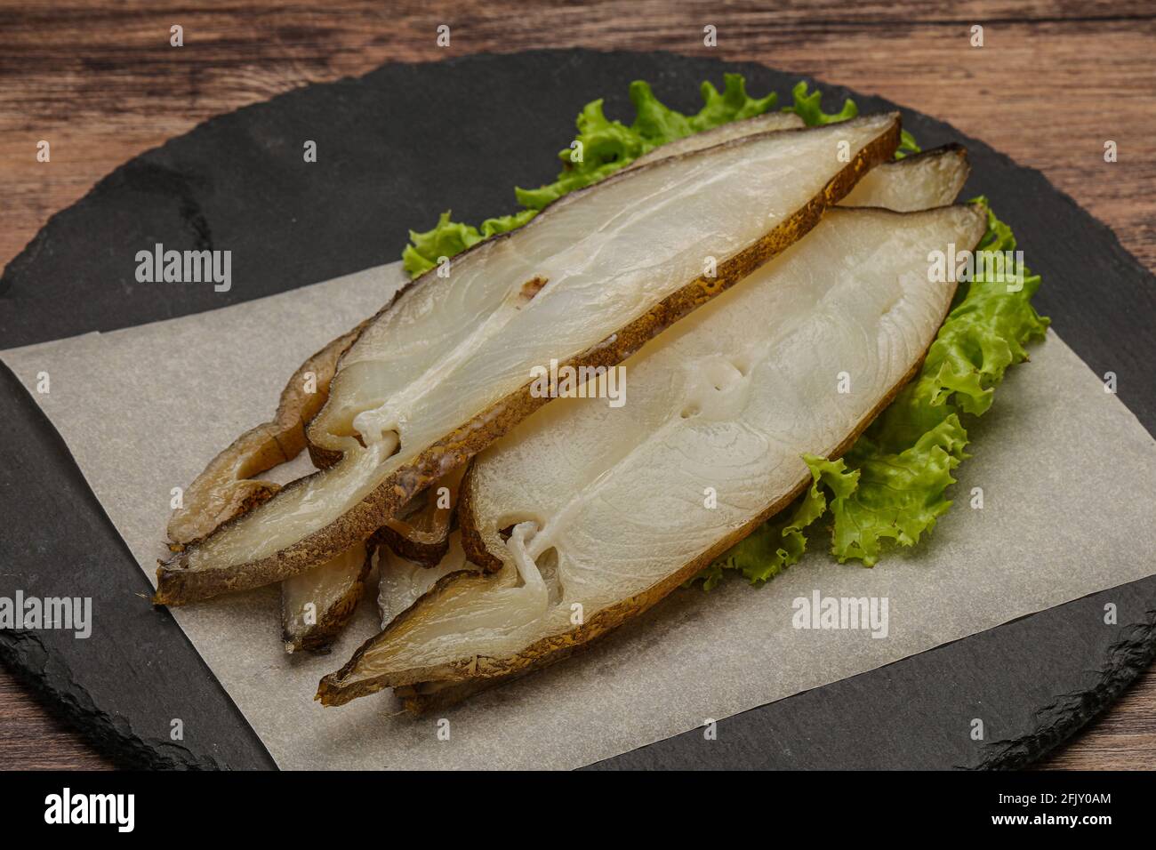Delicous smoked halibut fish slices snack Stock Photo - Alamy