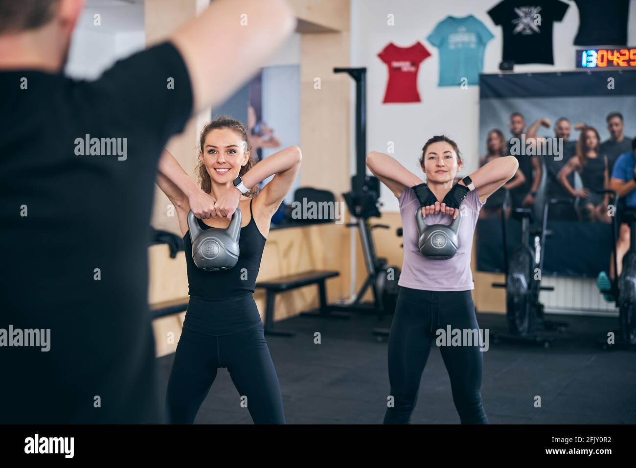 Three people doing a strength training exercise Stock Photo - Alamy