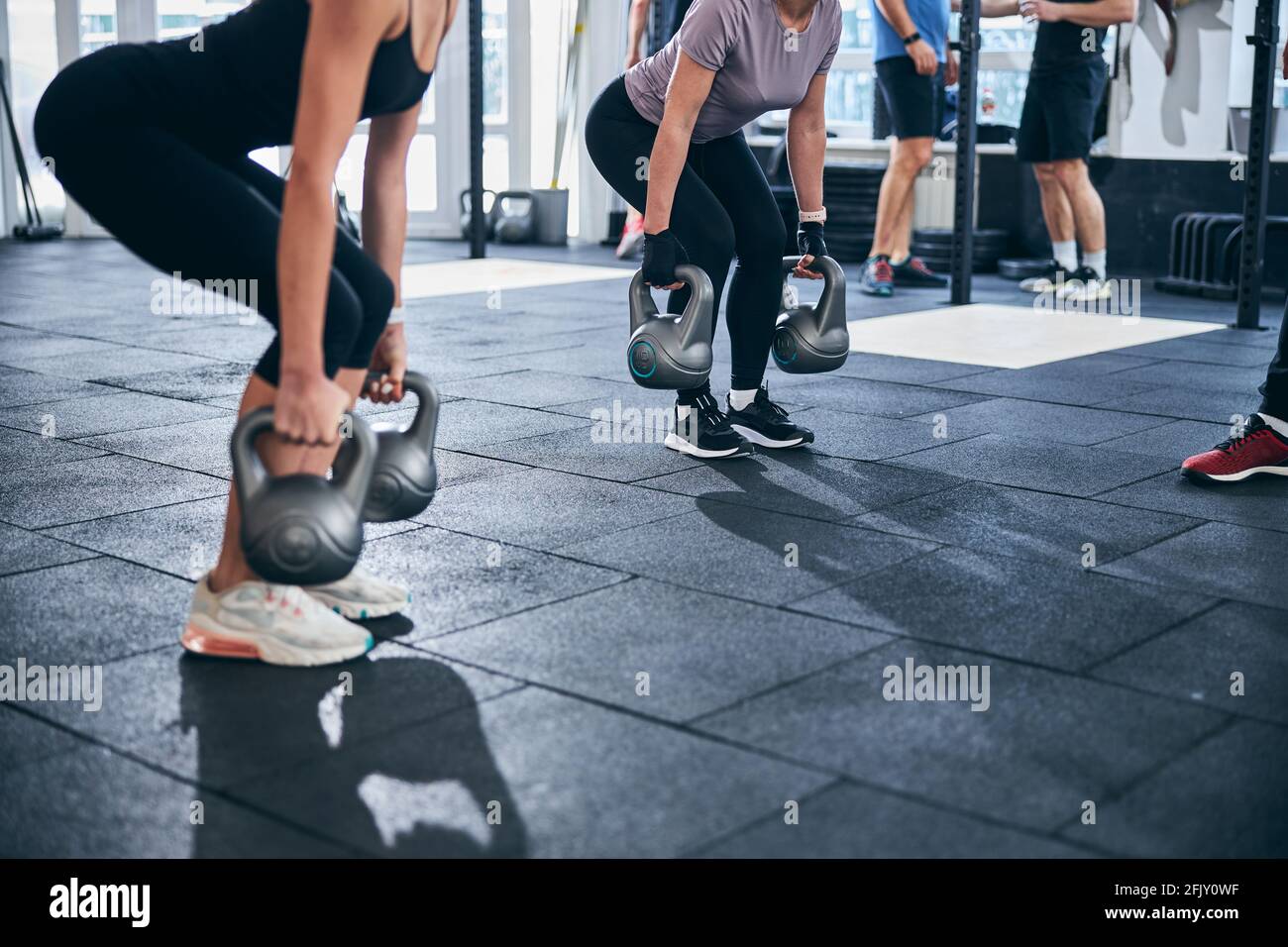 Young woman performing kettlebell deadlift hi-res stock photography and ...
