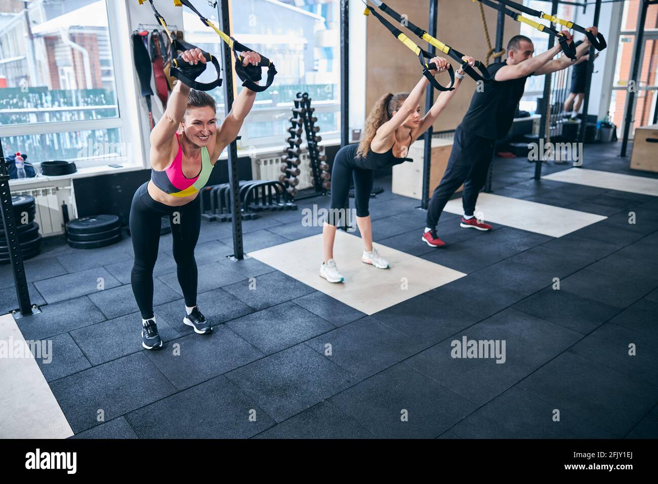 Man and female athletes doing a resistance exercise Stock Photo - Alamy
