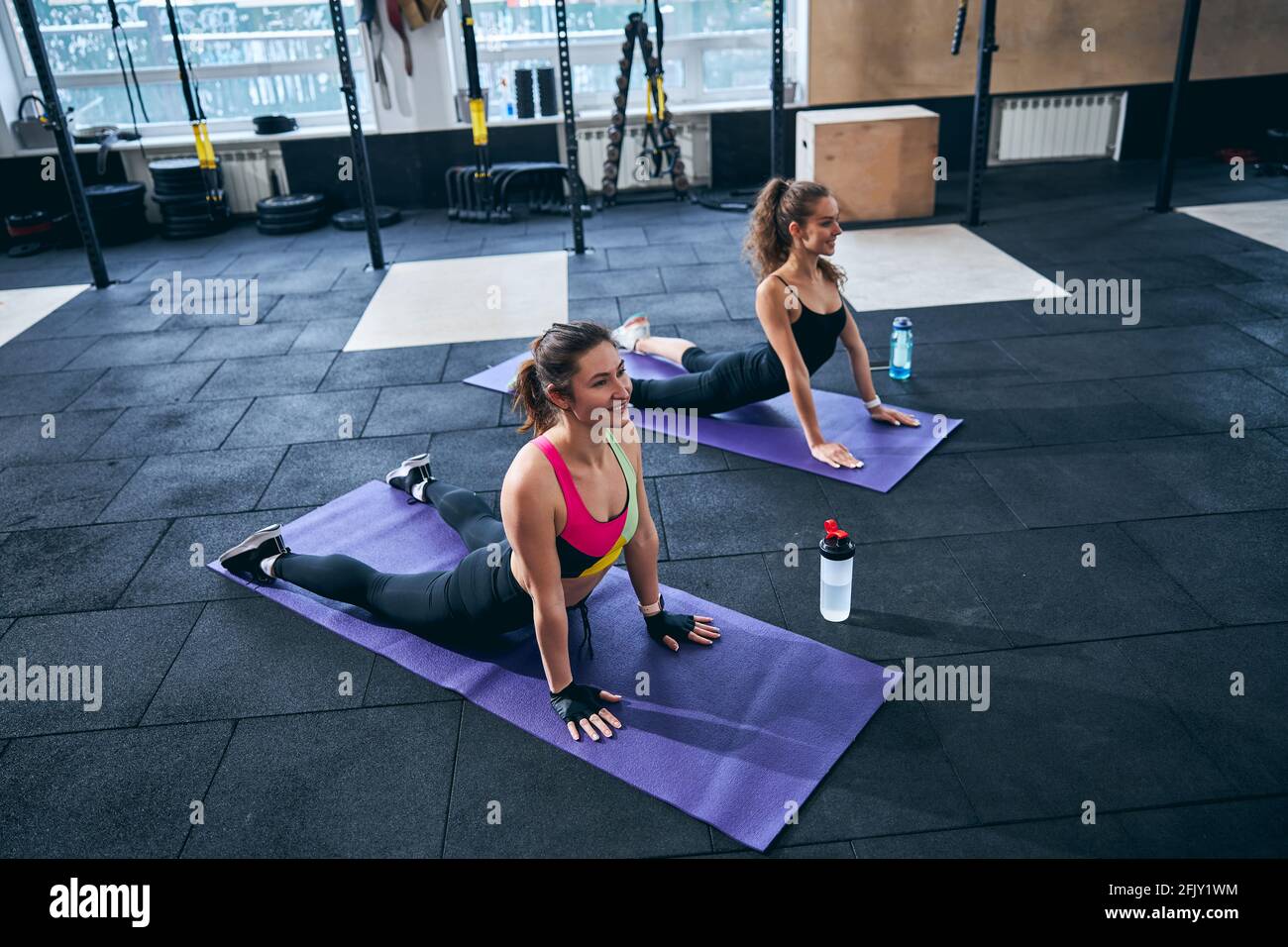 Joyous female athletes performing an abdominal stretch Stock Photo - Alamy