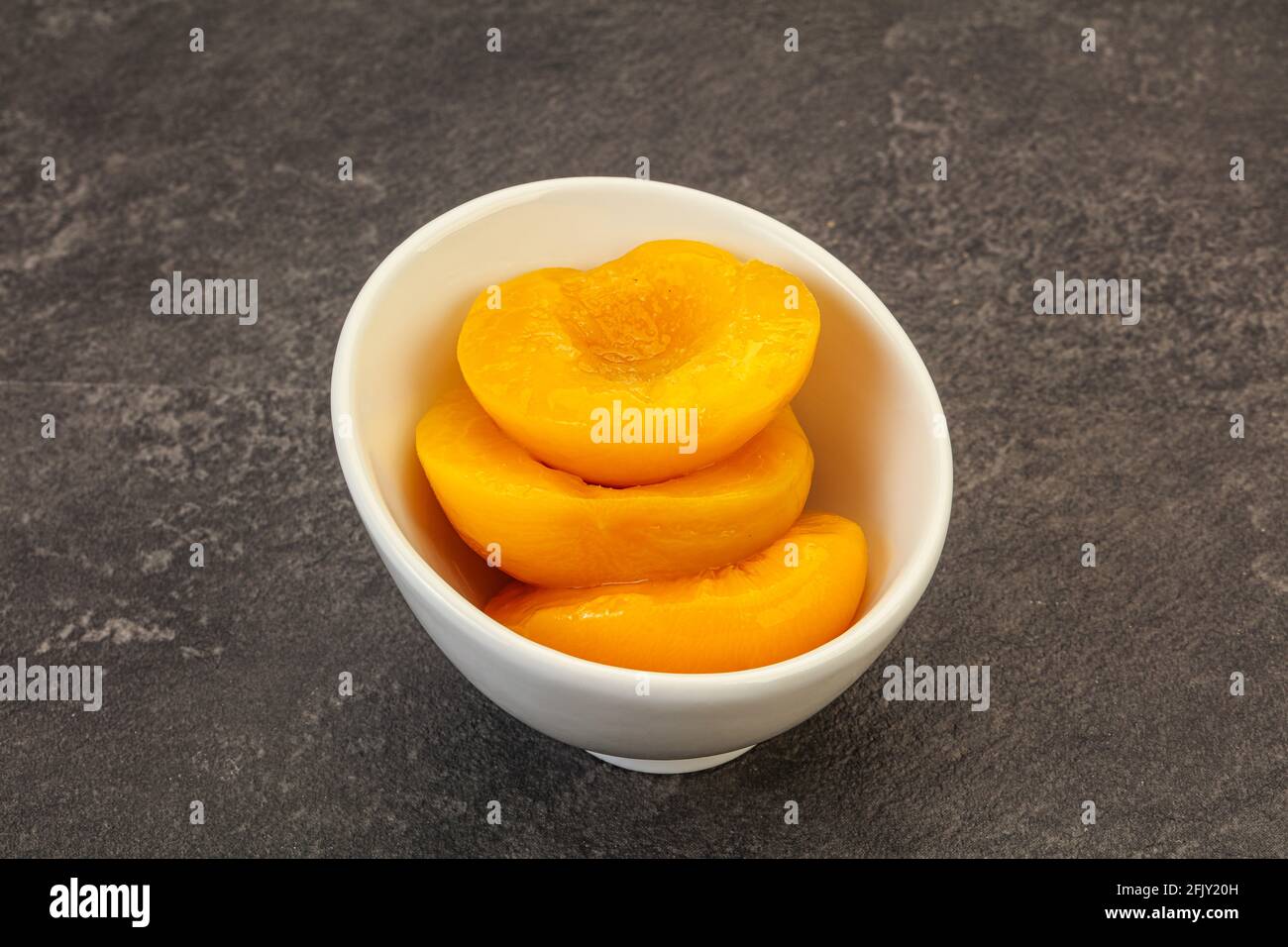 Marinated peaches fruit in the bowl with syrope Stock Photo - Alamy