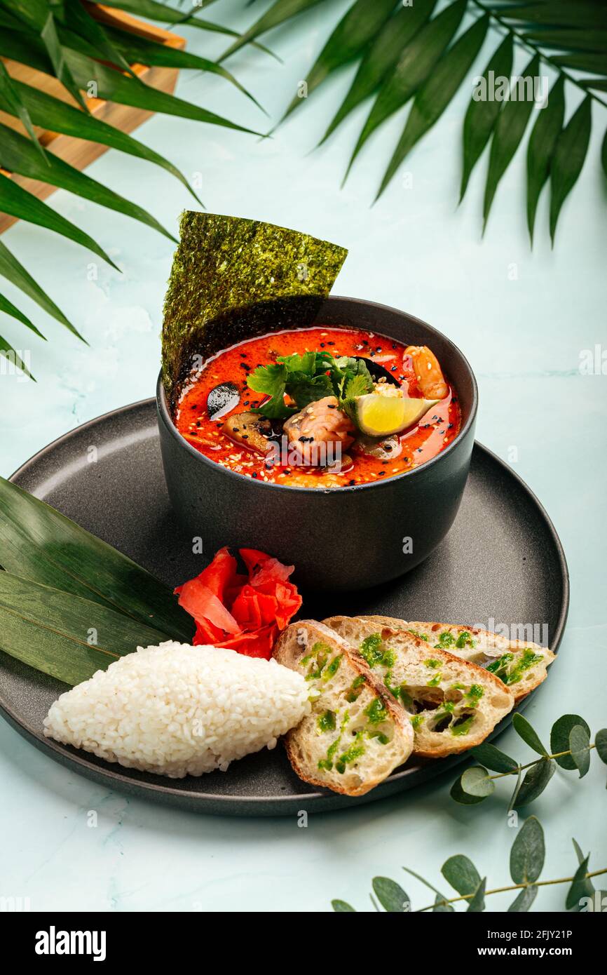 Tom yam soup with seafood red fish and nori Stock Photo - Alamy