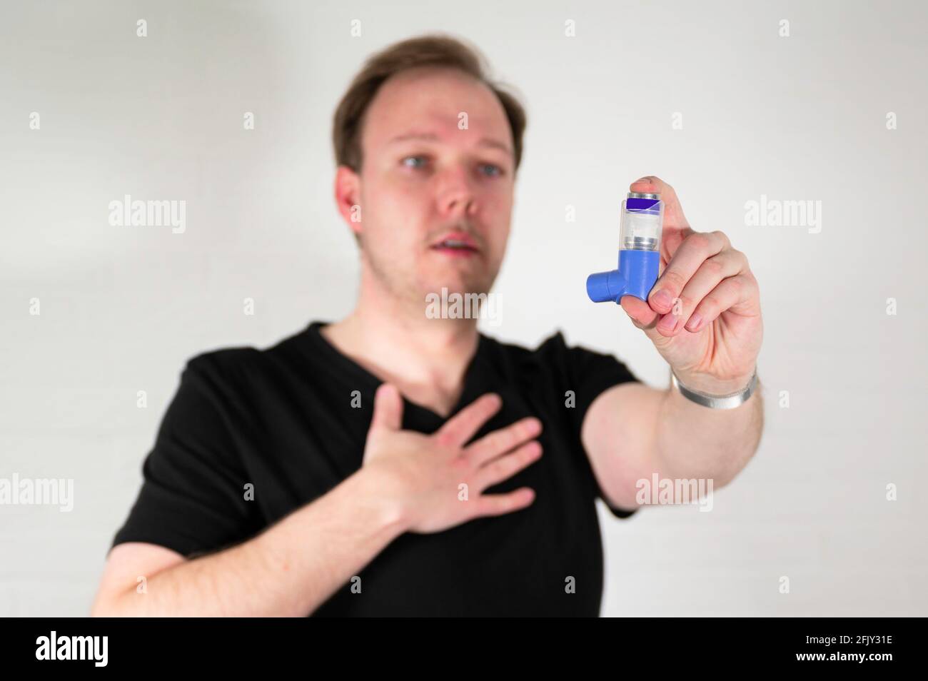 Man using an asthma spray inhaler Stock Photo - Alamy