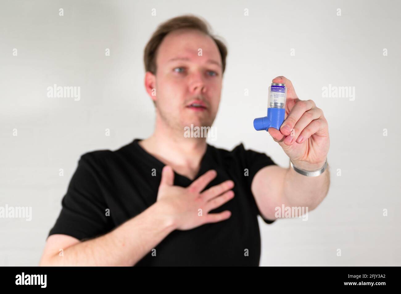 Man using an asthma spray inhaler Stock Photo - Alamy
