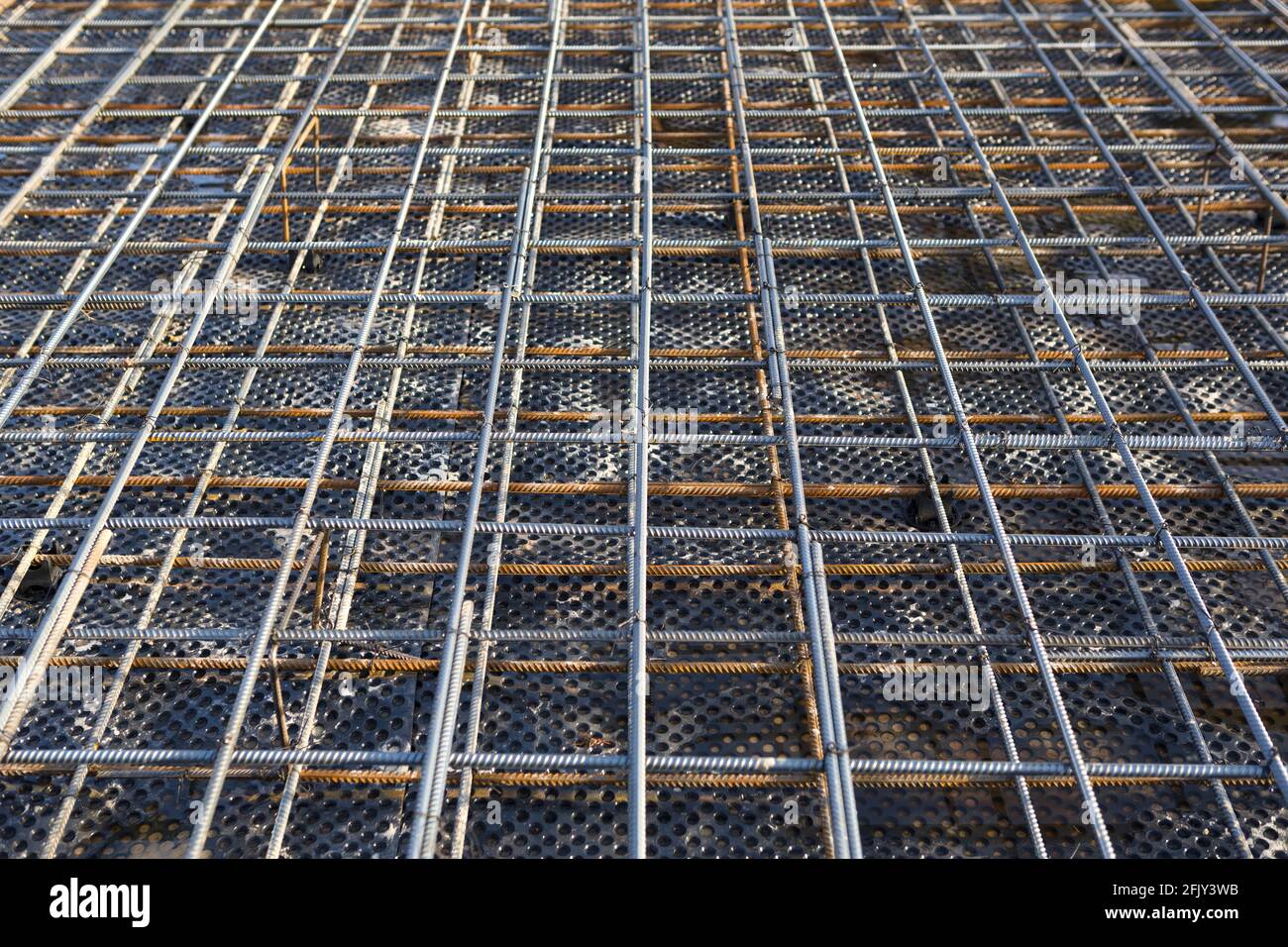 Iron fittings on a wooden blind area with laid pipes are the basis for ...