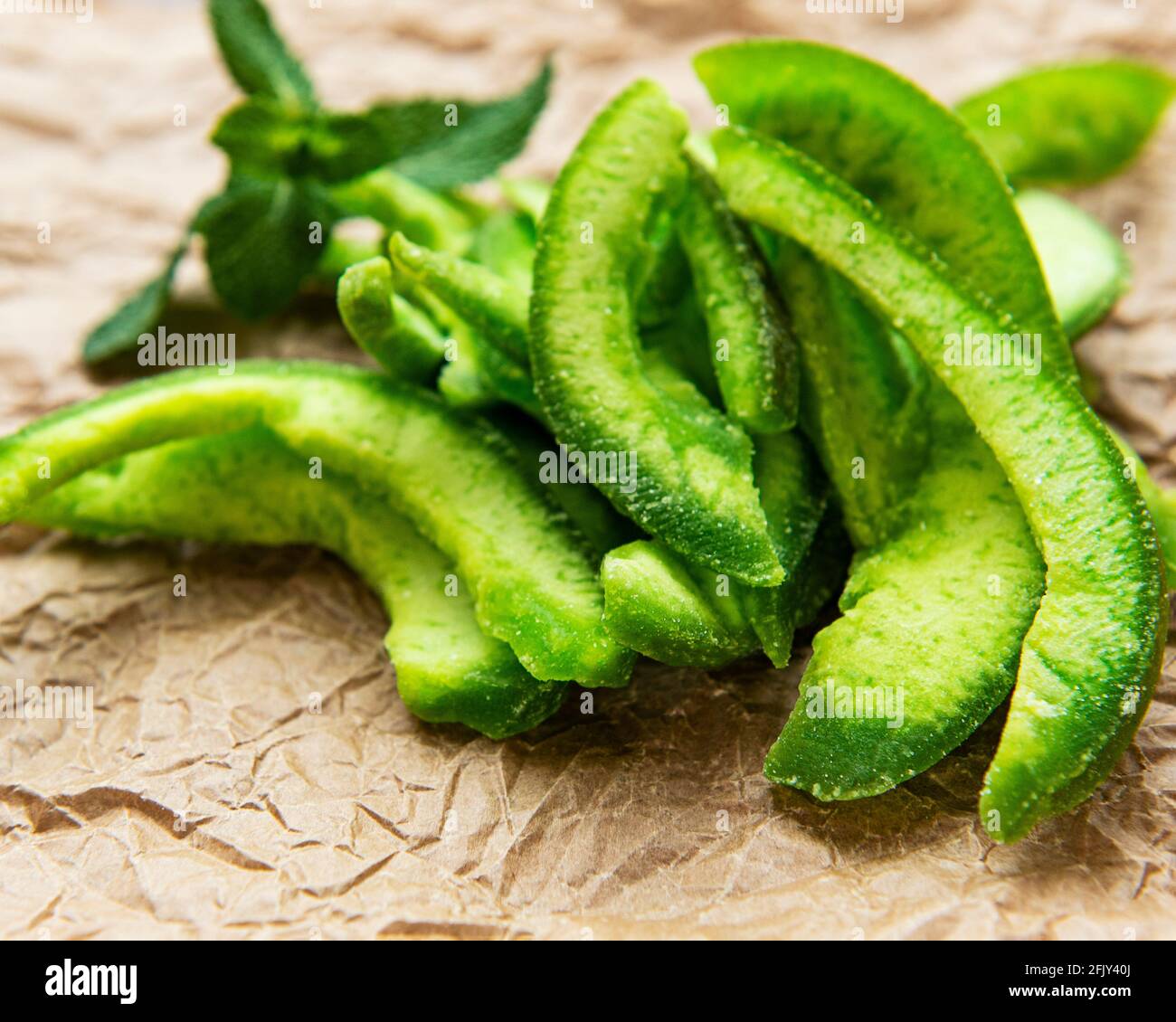 Dry chunks of pomelo on a plate on a brown paper background Stock Photo ...