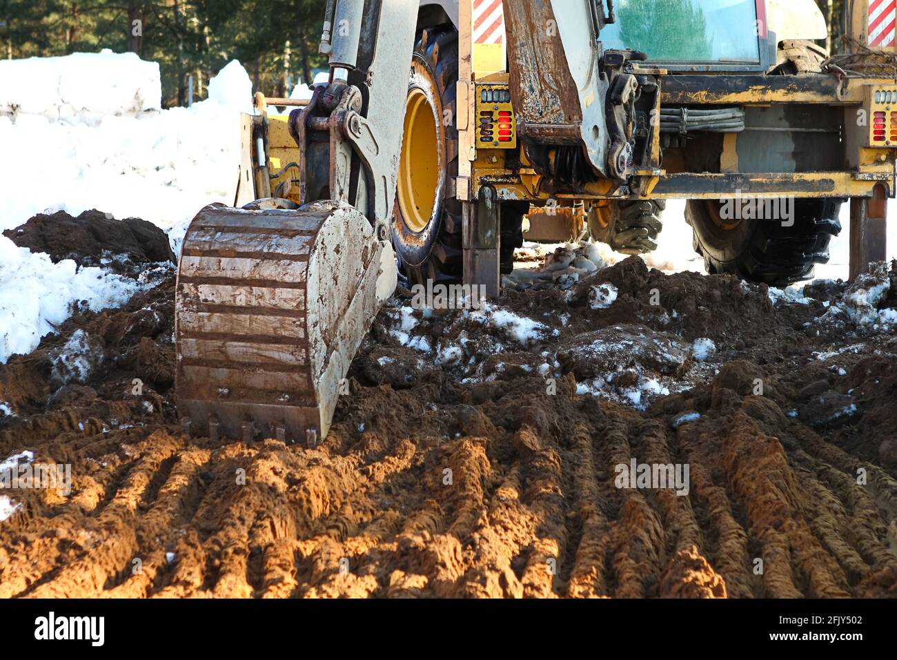 Bulldozer bucket close-up digs a pit for the construction. The ...