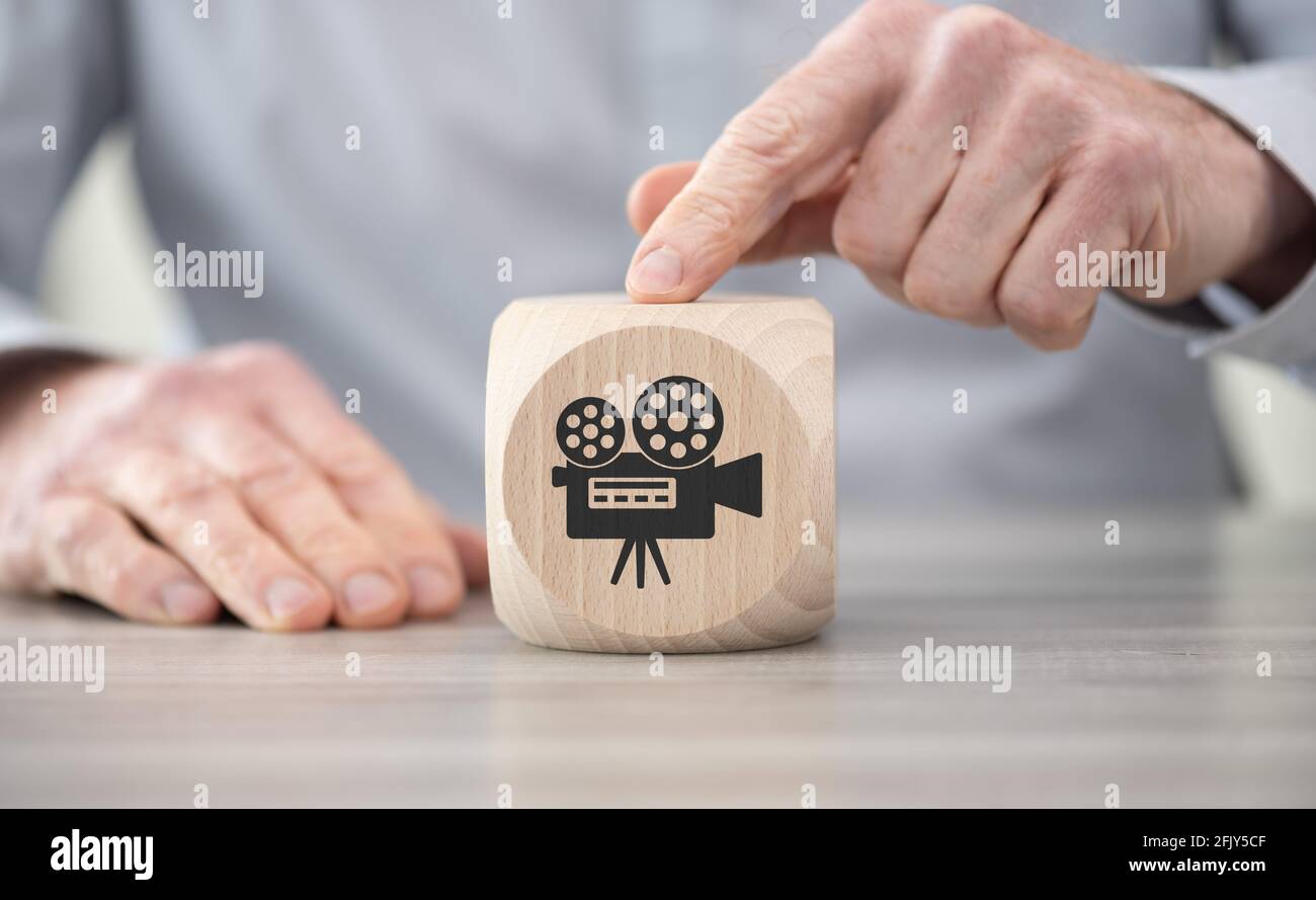 Wooden block with symbol of cinema concept Stock Photo - Alamy