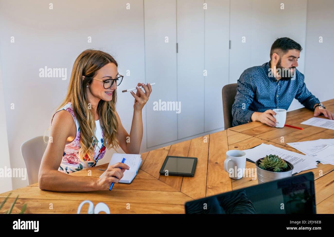 Office worker talking mobile phone with speaker Stock Photo - Alamy