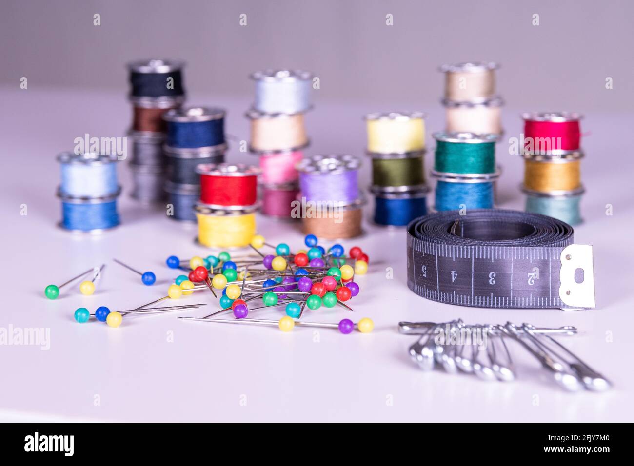 Inside a sewing kit: Colorful thread reels, pins, measuring tape and ...