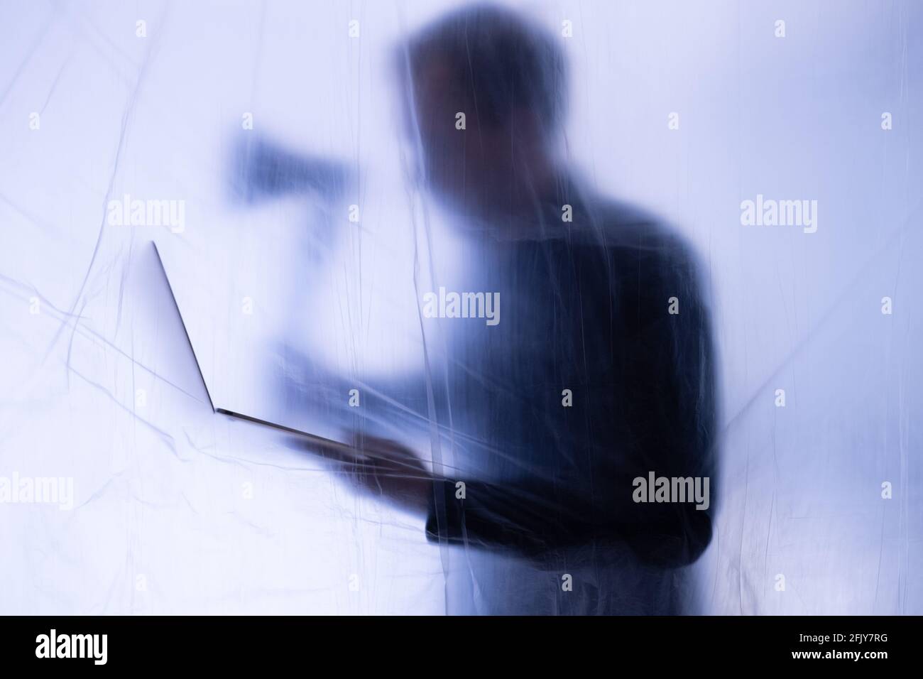 Anonymous Hacker commits computer crime Stock Photo - Alamy