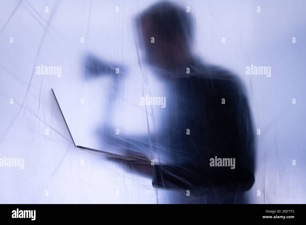 Anonymous Hacker commits computer crime Stock Photo - Alamy