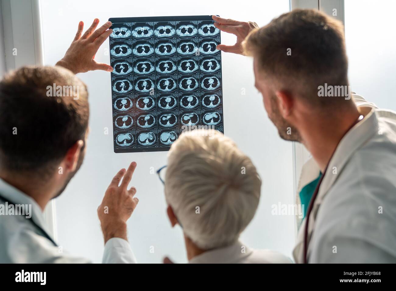 Group of doctor looking at ct scan at hospital to make diagnosis Stock ...