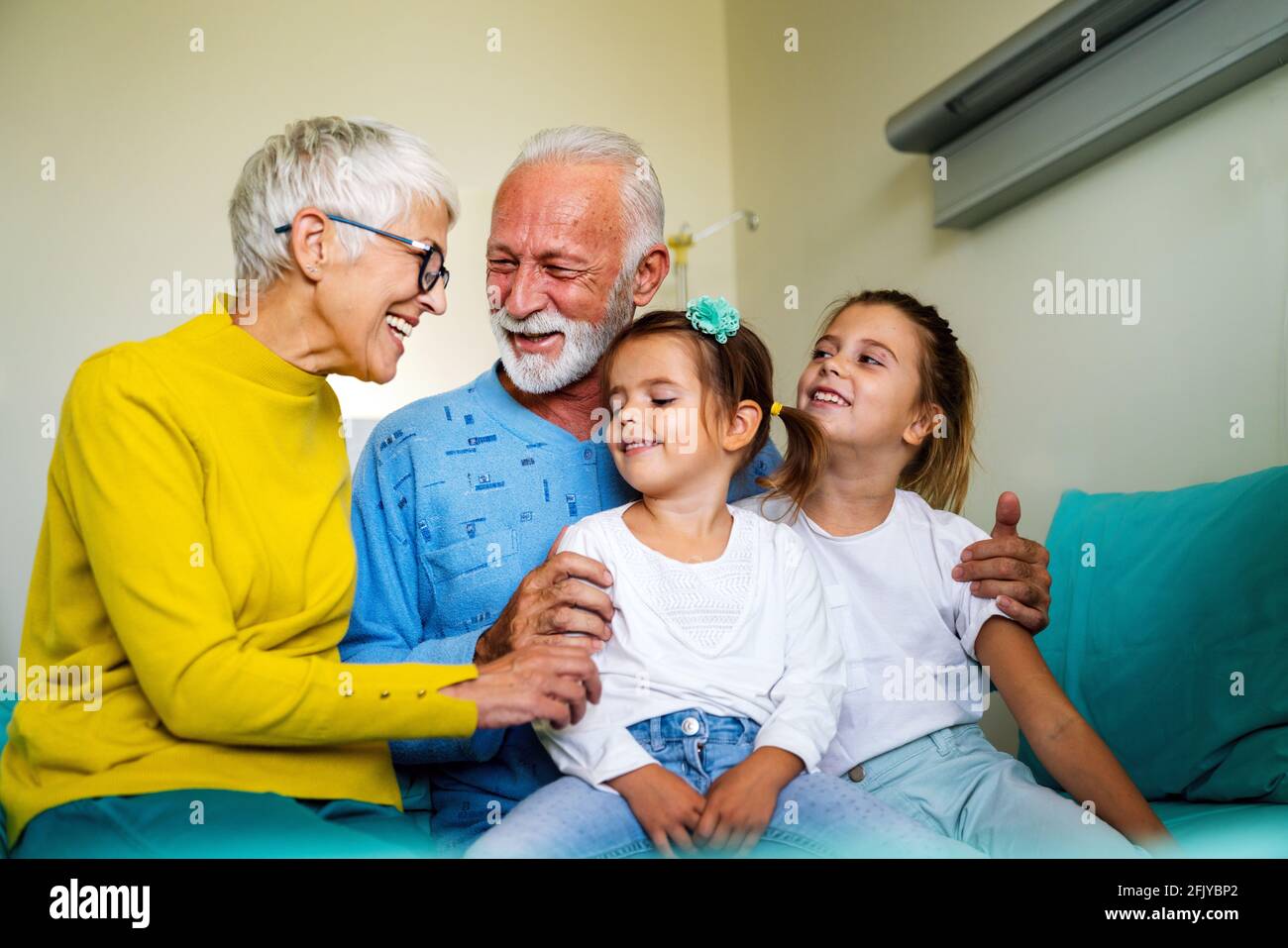 Family visiting senior male patient in hospital bed. Healthcare ...