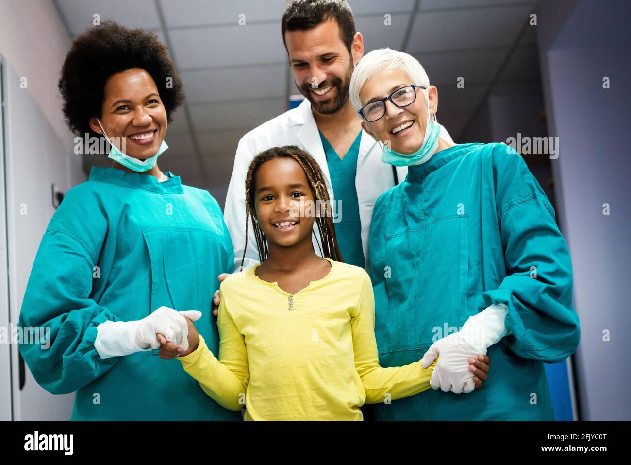 Team of experienced highly qualified doctors with child patient after a ...