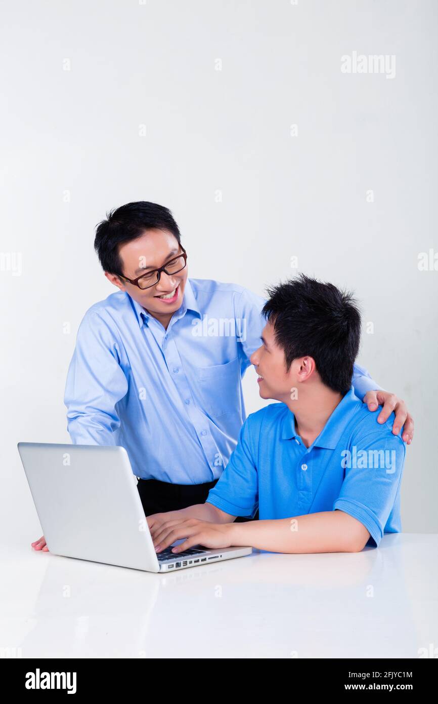 Chinese father helps his son with knowledge and experience for his ...