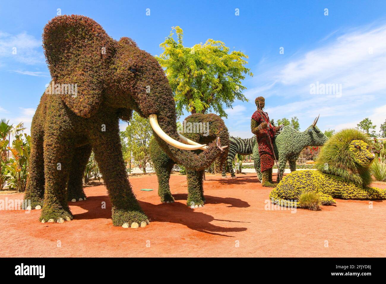 Figure of Lion, Elephant, Zebra made of green lawn grass in the park ...