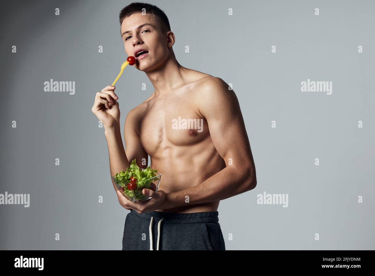 sport man healthy eating fresh salad isolated background workout Stock ...