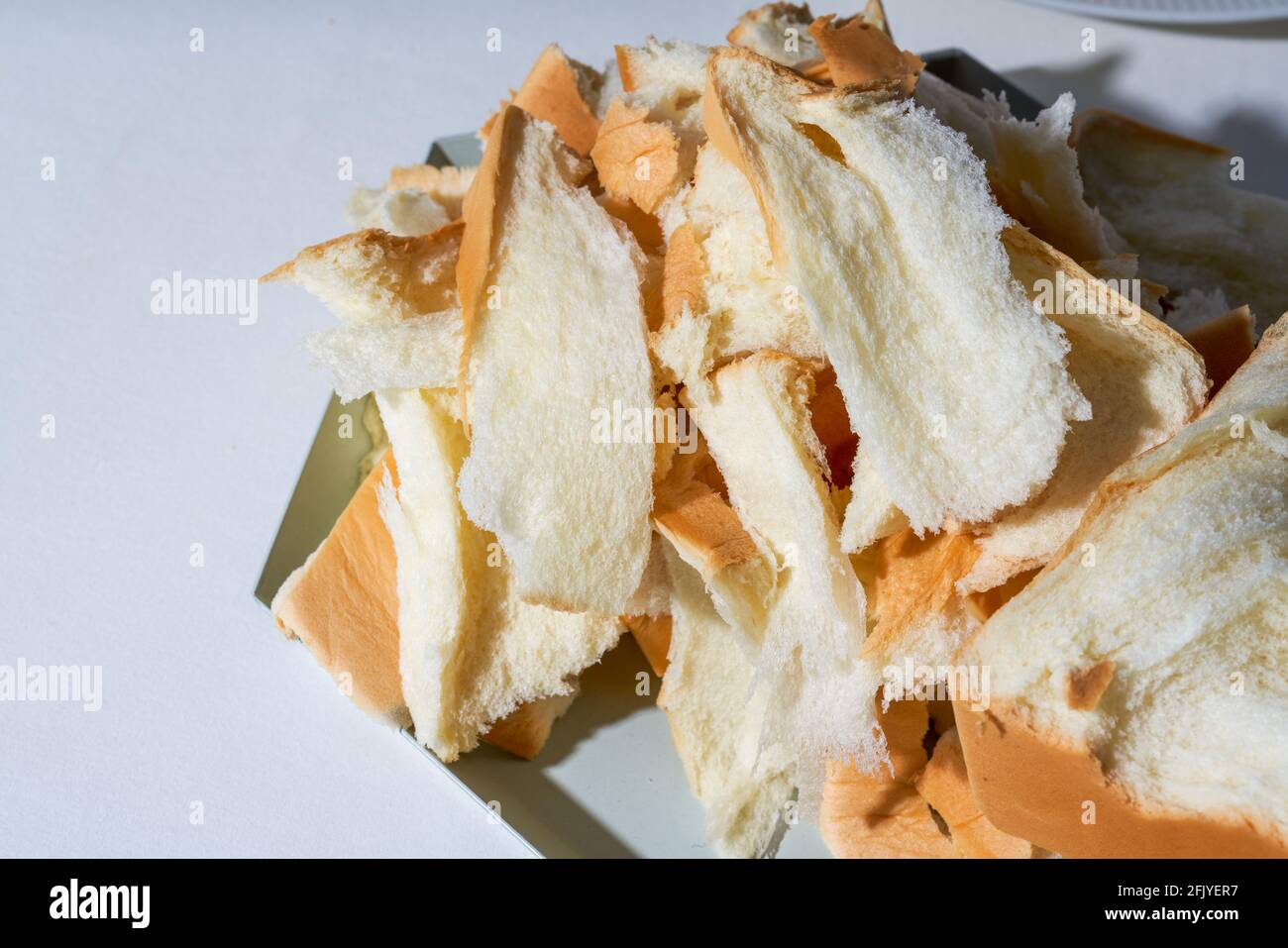 A plate of shredded raw toast bread, shredded toast Stock Photo - Alamy