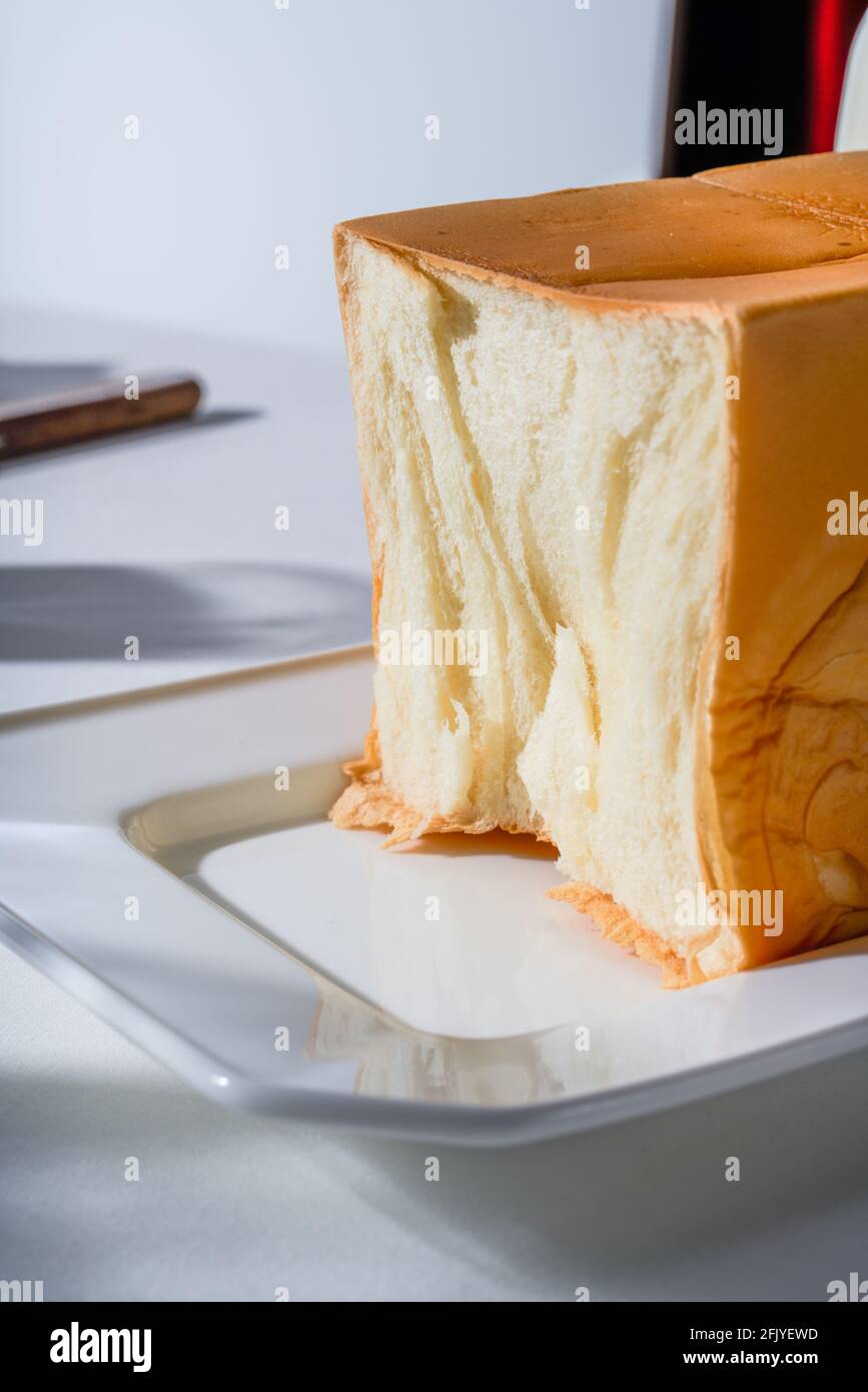 A piece of torn square toast bread Stock Photo - Alamy