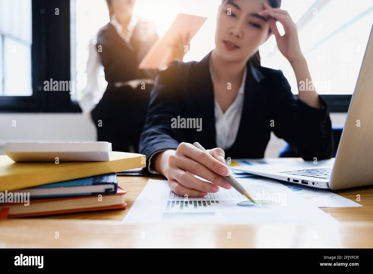 Stressed business woman hard working until morning and tired at table ...