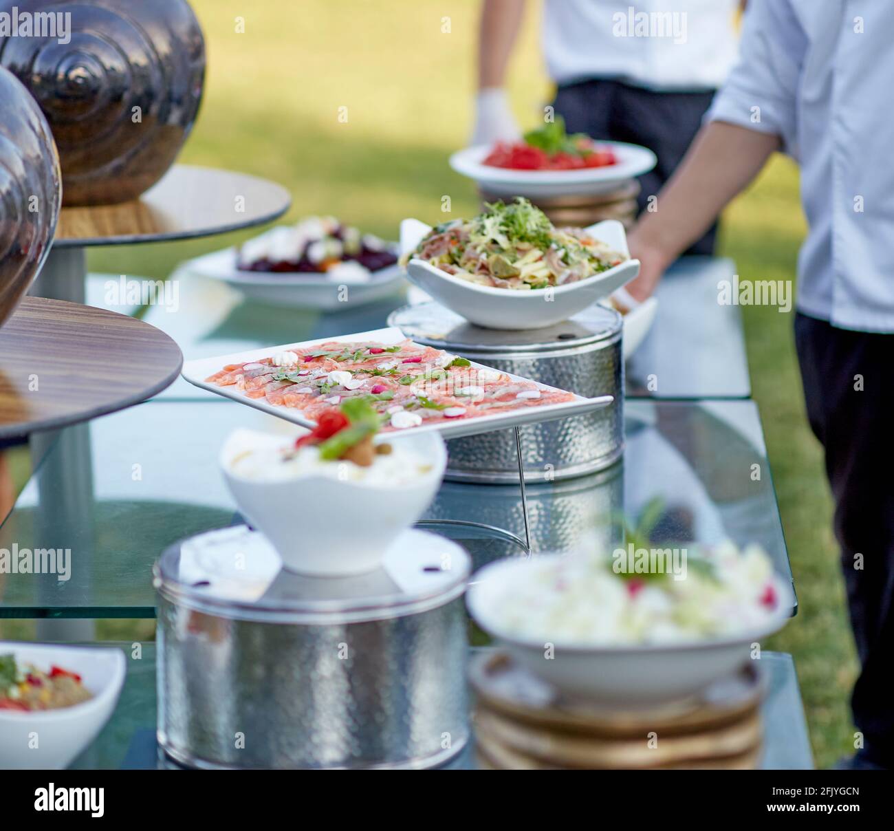 Outdoor catering banquet in summer. Table with snacks, canapes and ...
