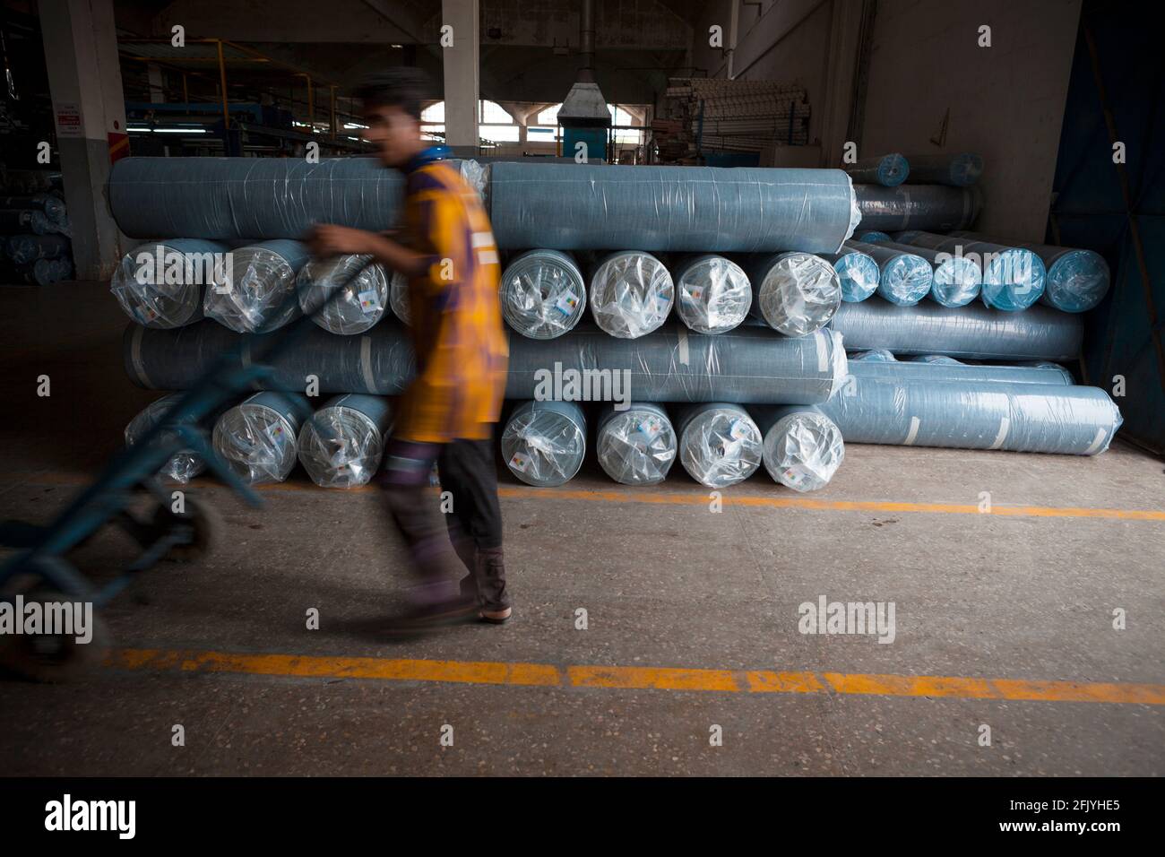 Weaving fabric on air jet looms in big textile weaving unit Stock Photo ...