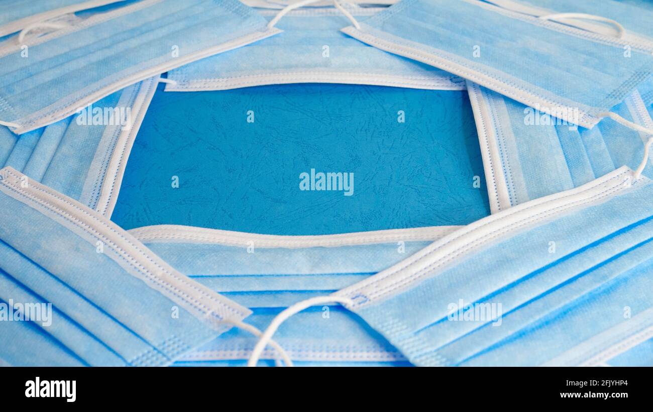 Layout made of medical masks with blue paper card note. Negative space ...