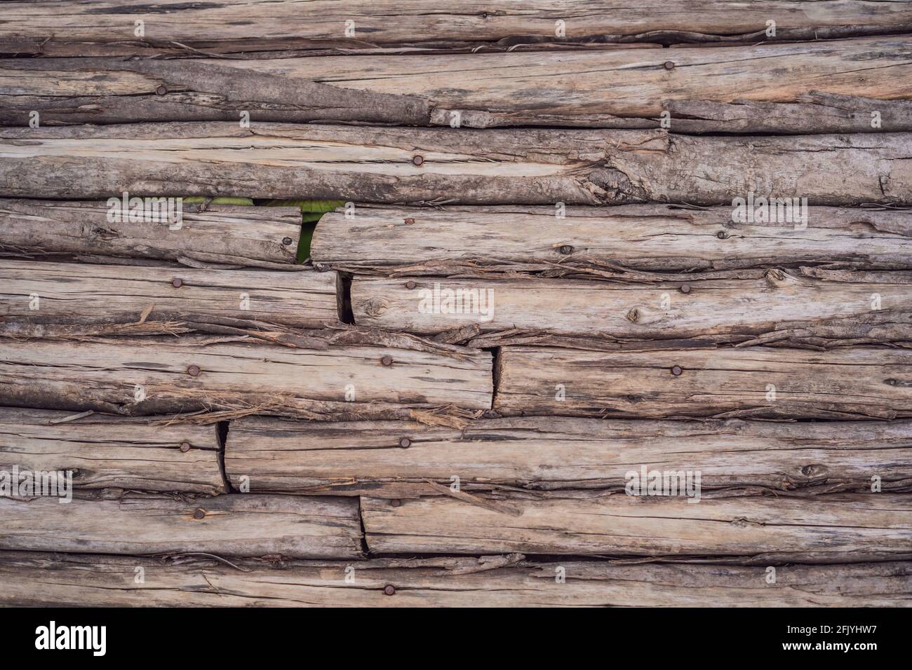 Wooden walkway made from old gray logs Stock Photo - Alamy