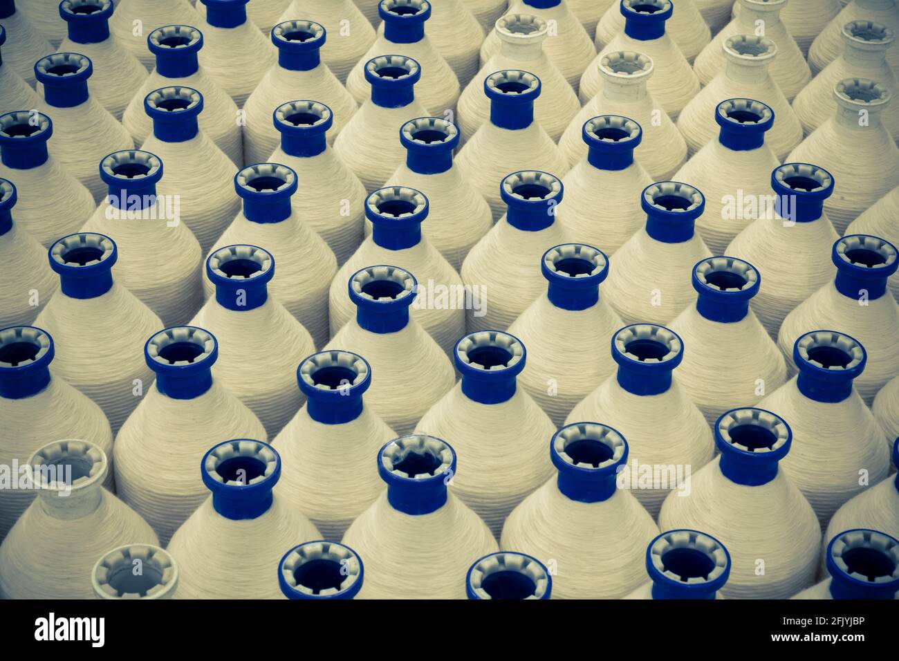 Stacks of empty spools in Textile Spinning unit Stock Photo - Alamy