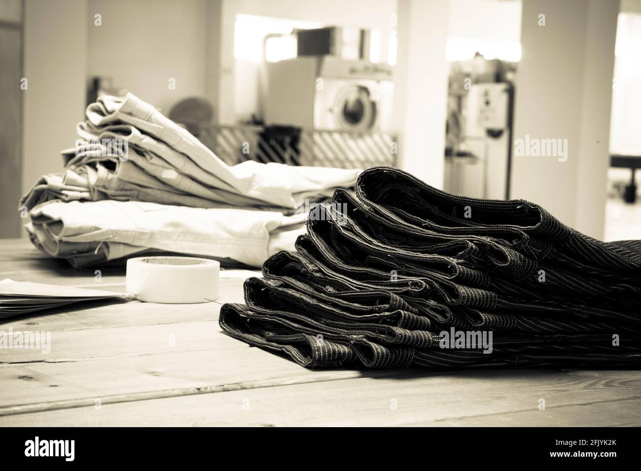Denim pants in front of industrial washers for special effects on jeans ...