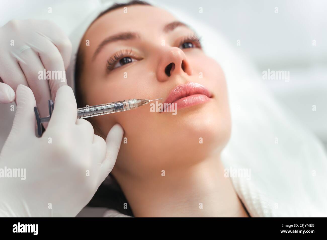 Lip augmentation and correction procedure in a cosmetology salon. The ...