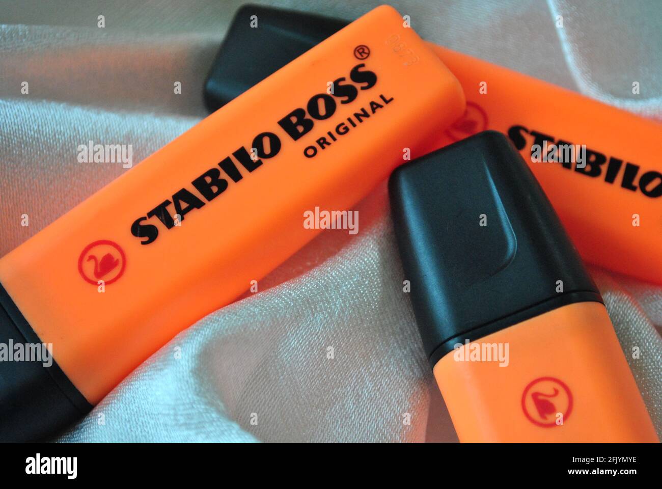 stationery which is an orange stabilo boss higlighter with white ...