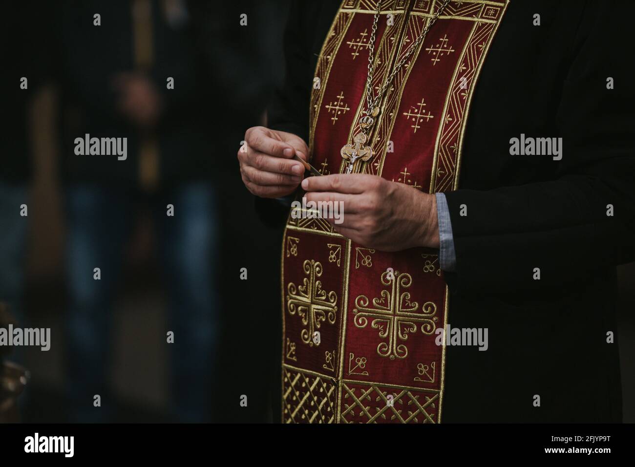 Closeup shot of a preacher wearing a beautifully designed robe in the ...