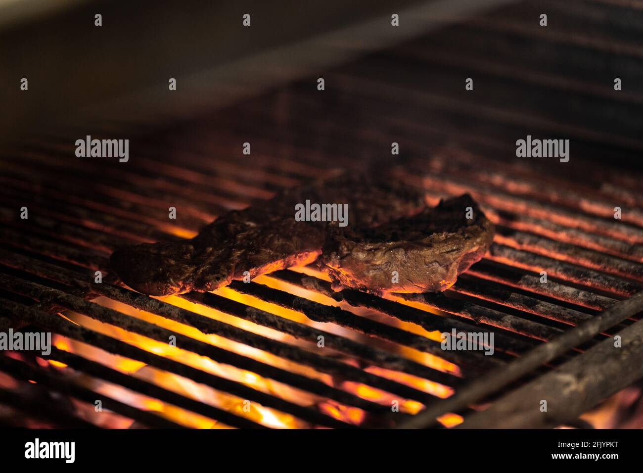 Closeup of steak on grill Stock Photo - Alamy