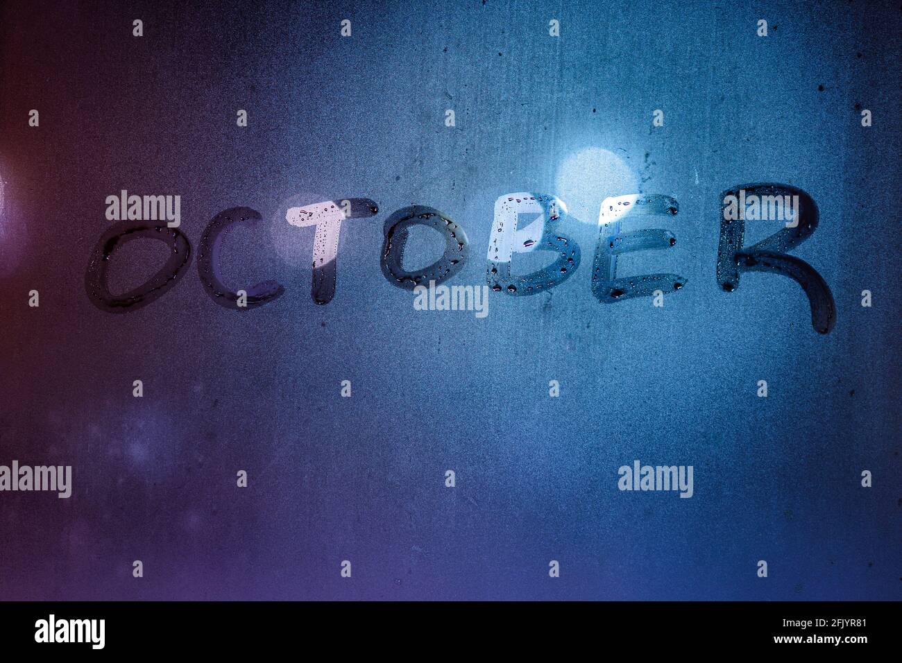 the word october handwritten on night wet window glass surface Stock ...