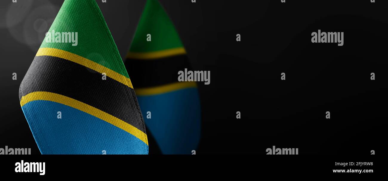 Small national flags of the Tanzania on a dark background Stock Photo ...