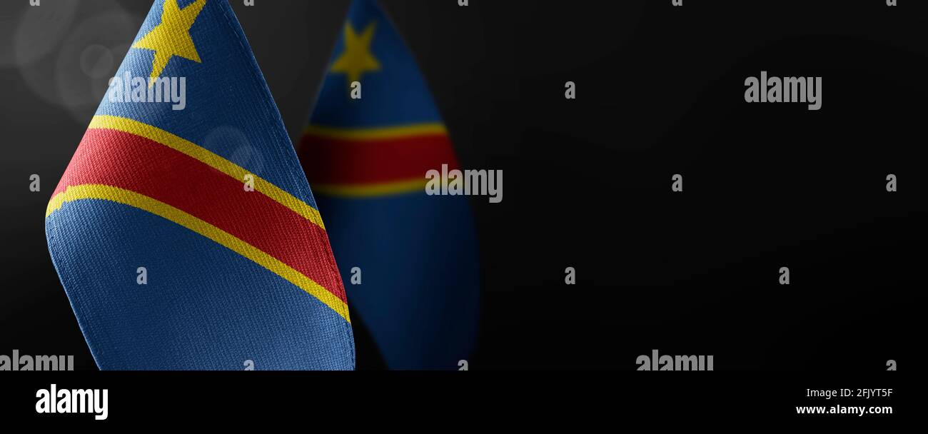 Small national flags of the Democratic Republic of the Congo on a dark ...