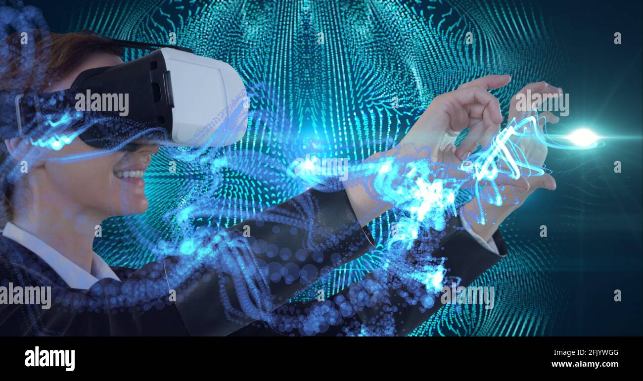 Composition of green light trails over woman wearing vr headset and ...