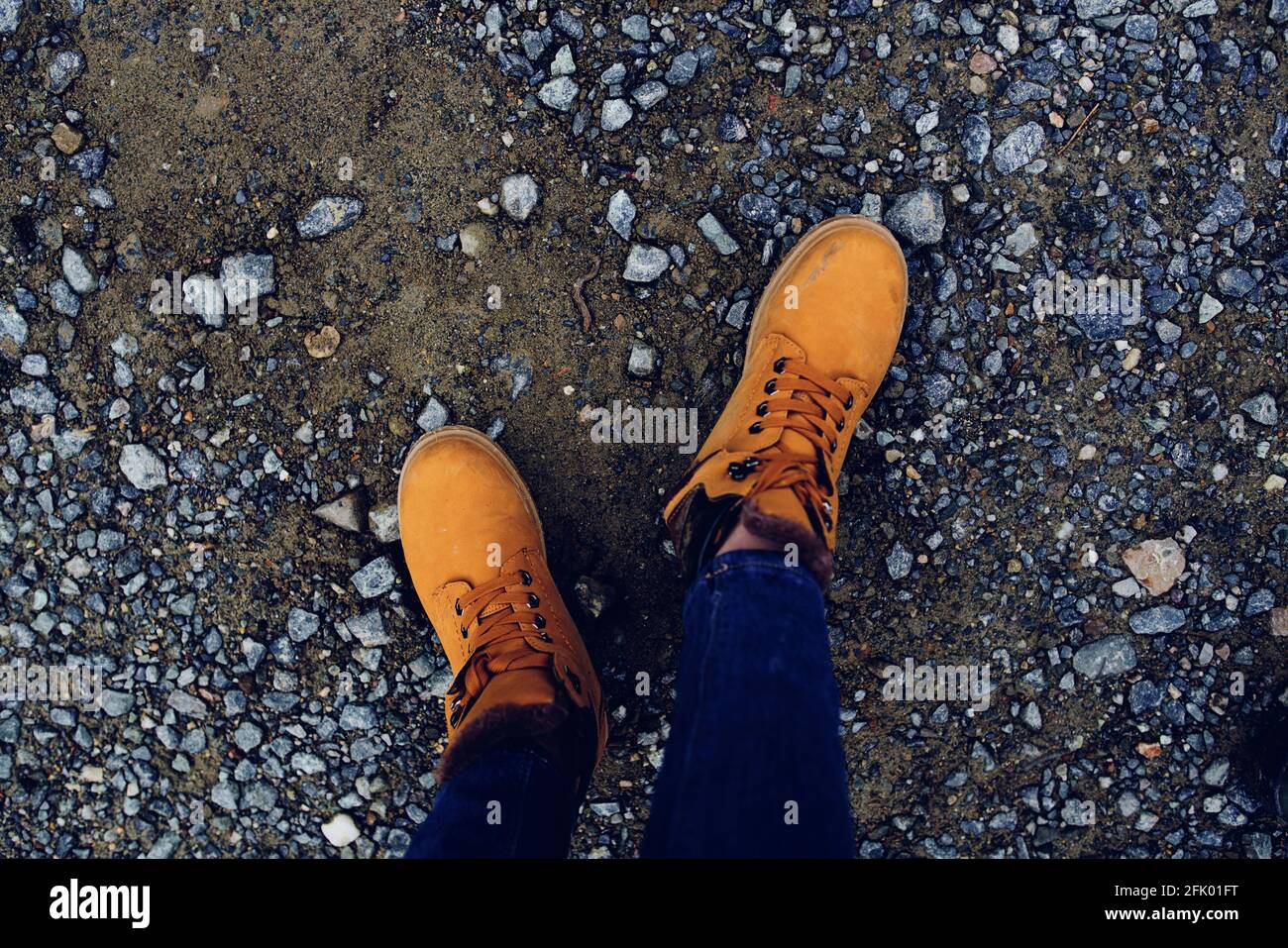 female feet in boots on the ground nature top view Stock Photo - Alamy
