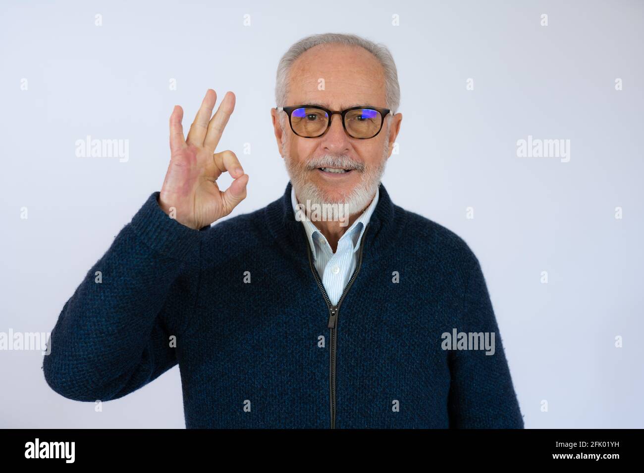 happy positive handsome old man shows okay sign over white background ...