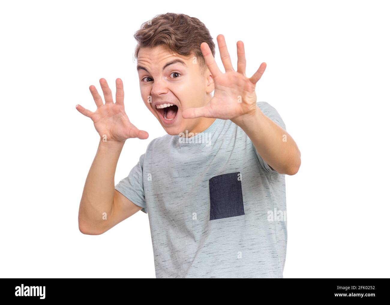 Emotional portrait of scared boy teenager, isolated on white background ...