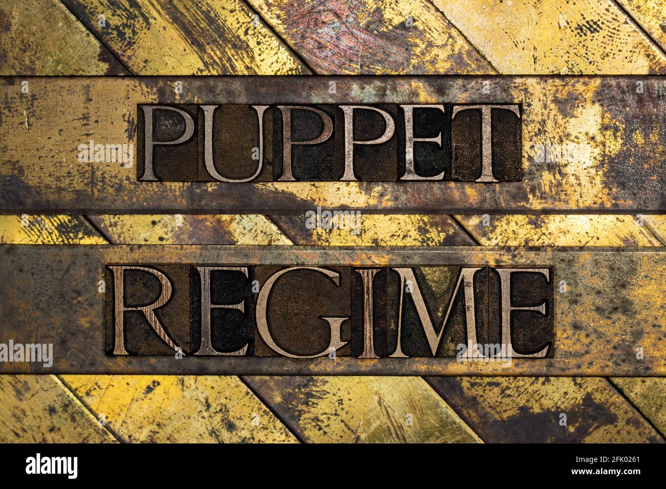 Puppet Regime text on vintage textured grunge copper and gold ...